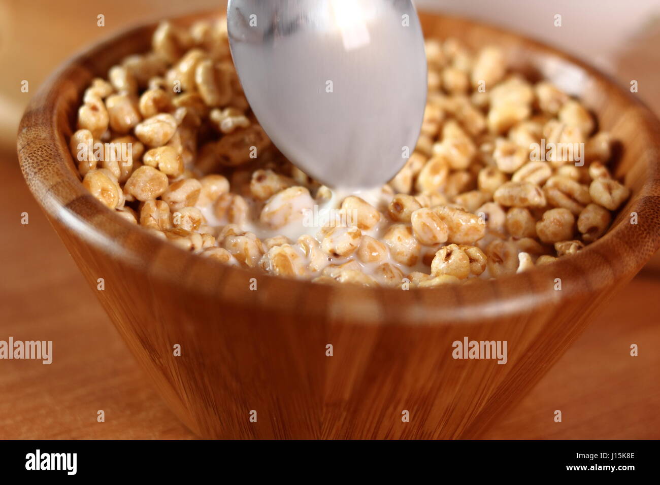 Whole Wheat Honey Puffs Cereal with Milk Stock Photo - Alamy