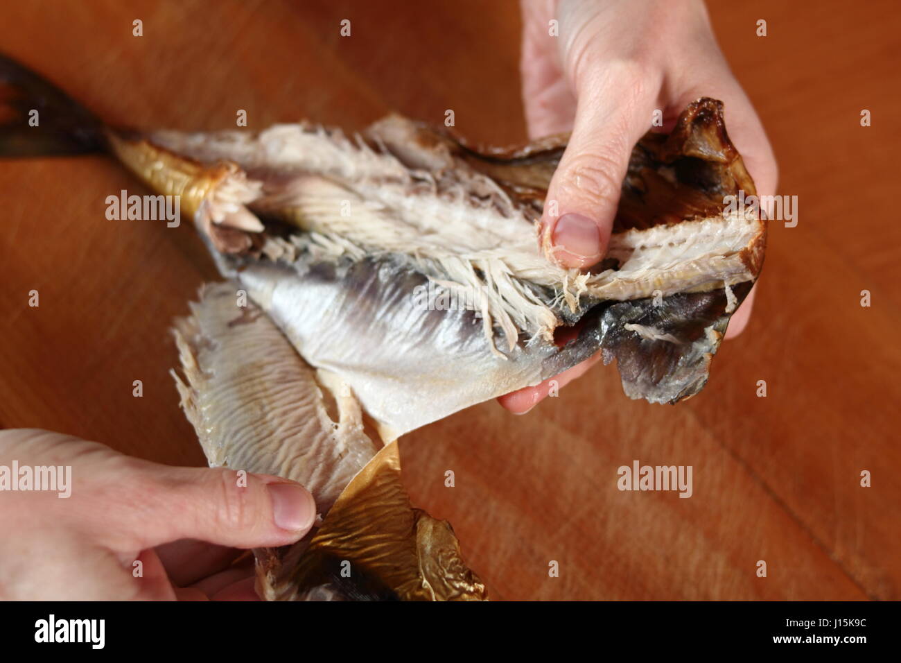 Woman removing fish hi-res stock photography and images - Alamy