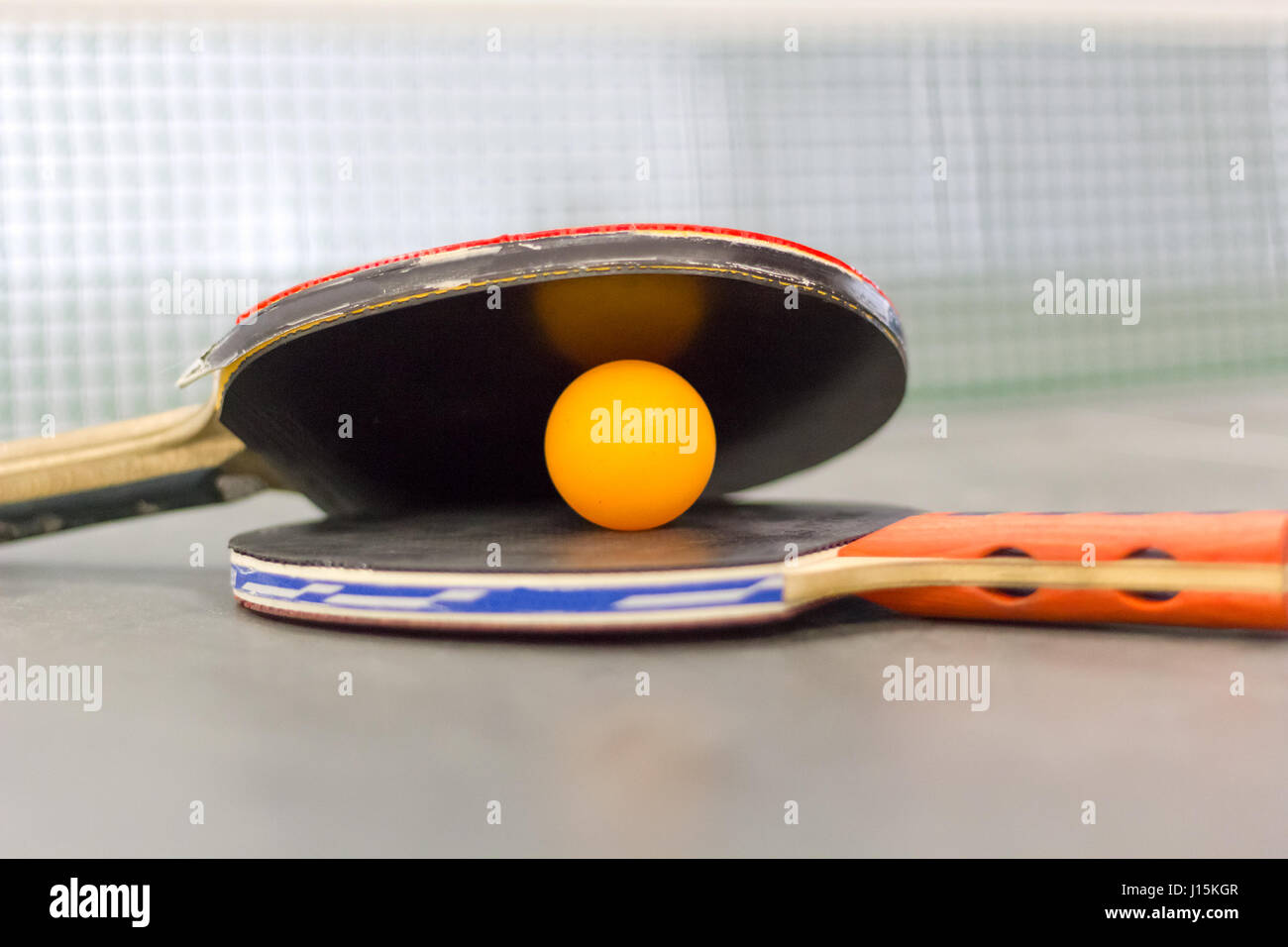 Two rackets and ball on table tennis table Stock Photo - Alamy