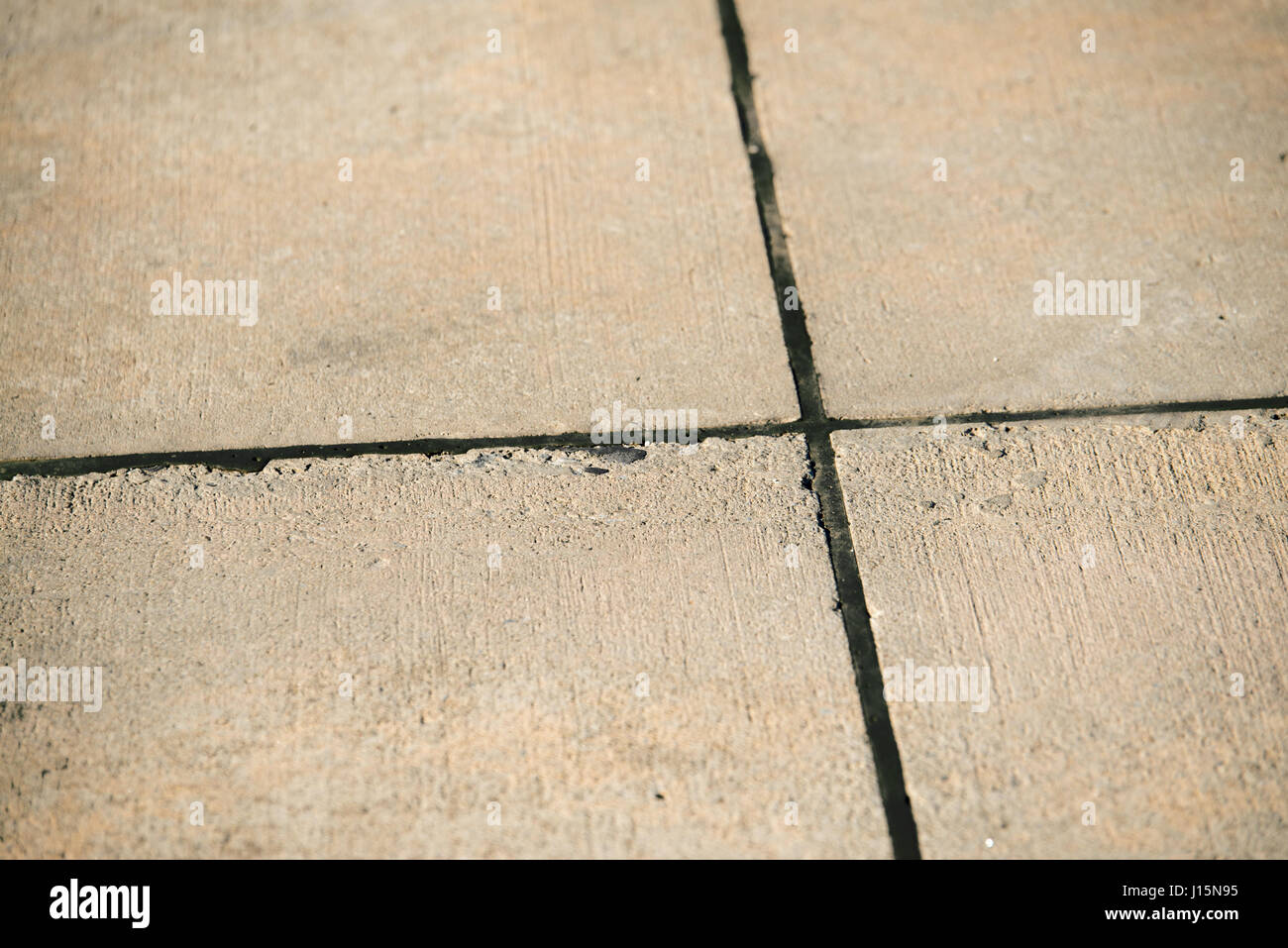 Empty gray concrete airport runway closeup with black sealant between ...