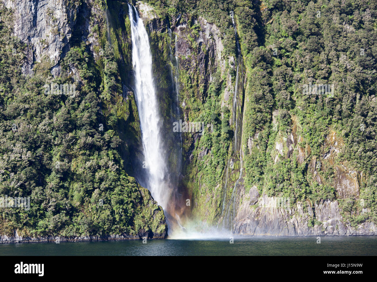The view of a waterfall in Milford Sound, the most popular part of ...
