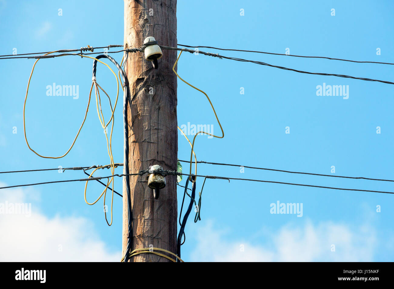 Old wooden pillar with power line Stock Photo - Alamy