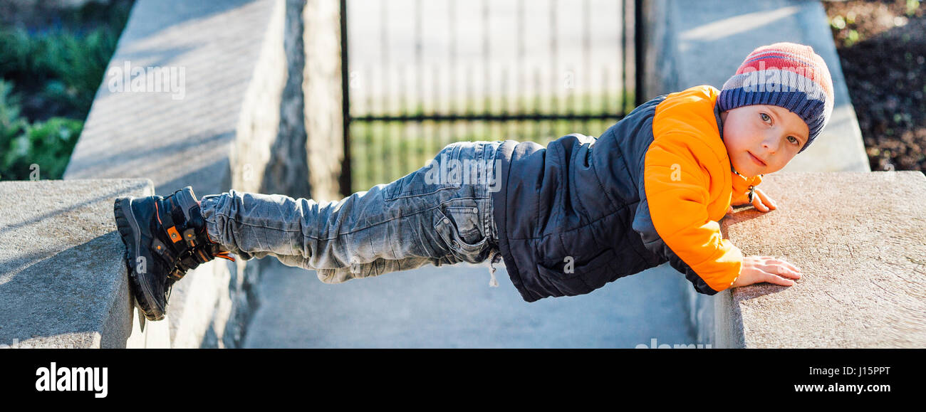 Little boy do push ups outside with sun background Stock Photo - Alamy