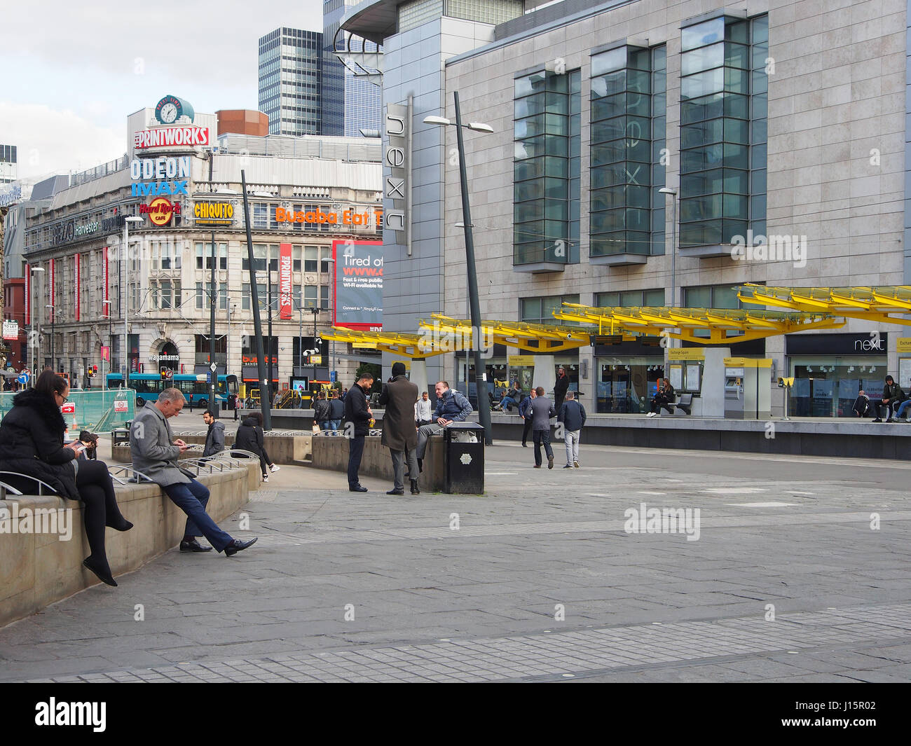 Exchange Square in the centre of Manchester, England, showing people ...