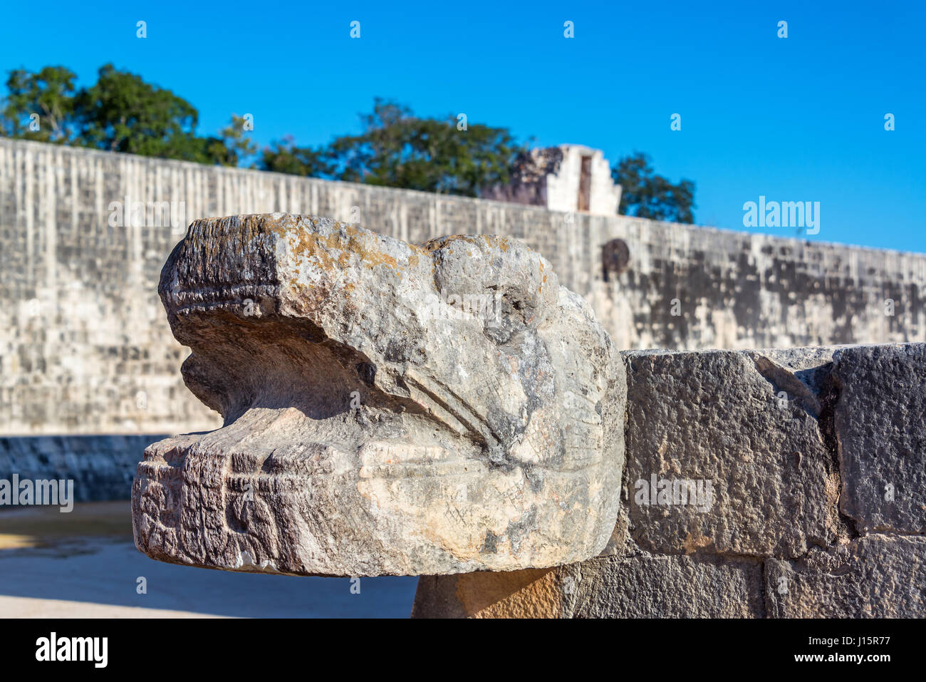 Snake head with the ball court in the background in the ancient Mayan ...