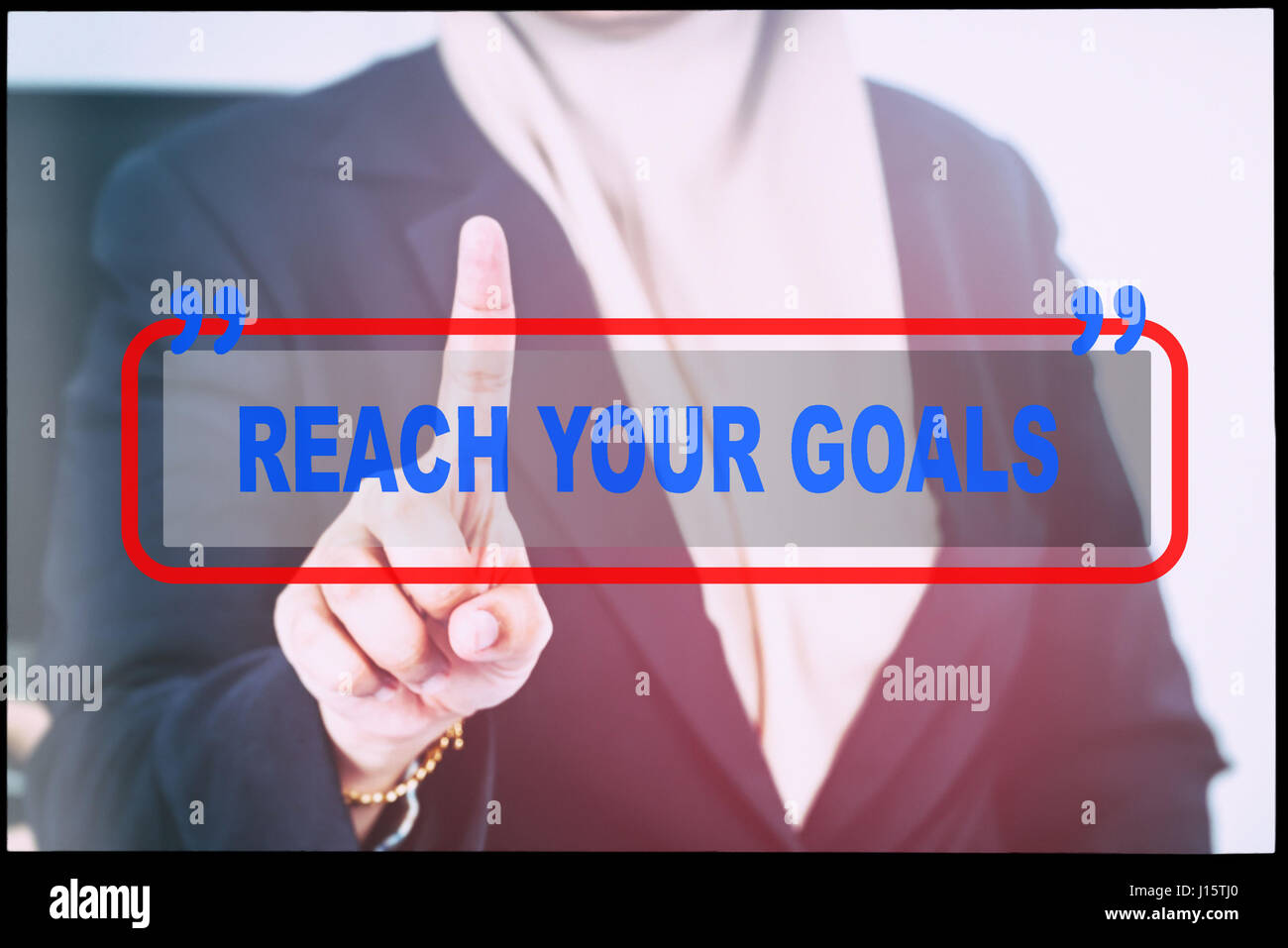 Hand and text "REACH YOUR GOALS" with vintage background. Technology ...