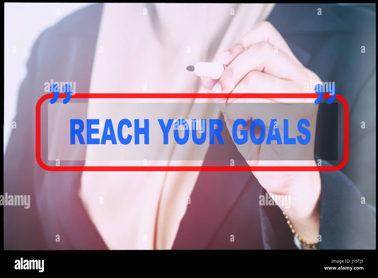 Hand and text "REACH YOUR GOALS" with vintage background. Technology ...