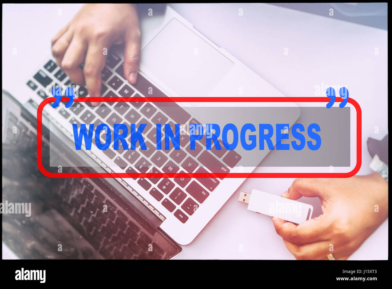 Hand and text "WORK IN PROGRESS" with vintage background. Technology ...