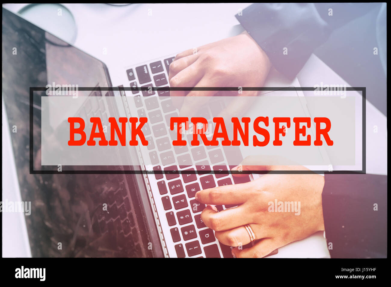 Hand and text BANK TRANSFER with vintage background. Technology concept ...