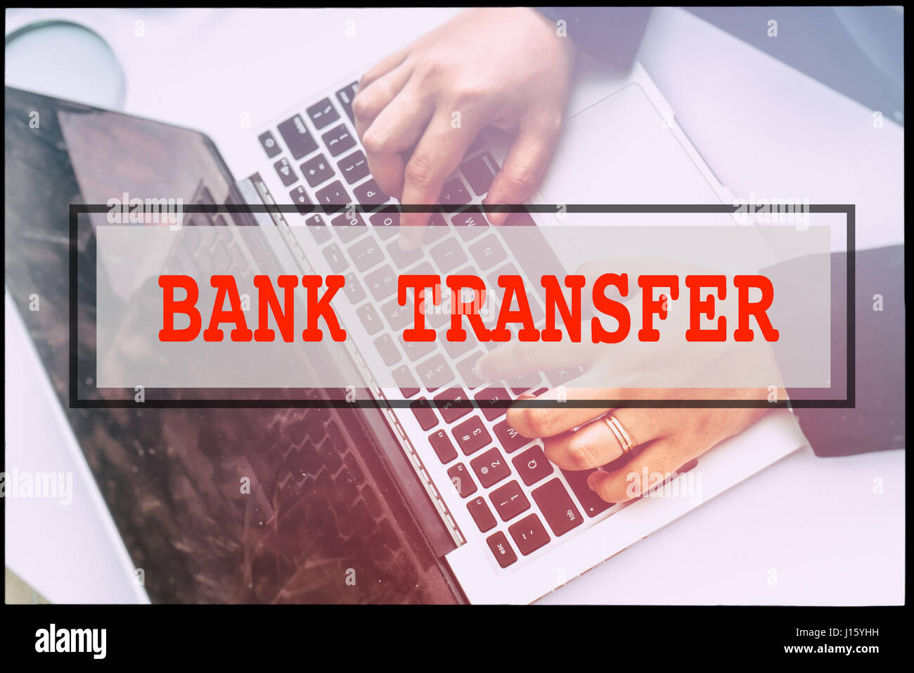 Hand and text BANK TRANSFER with vintage background. Technology concept ...