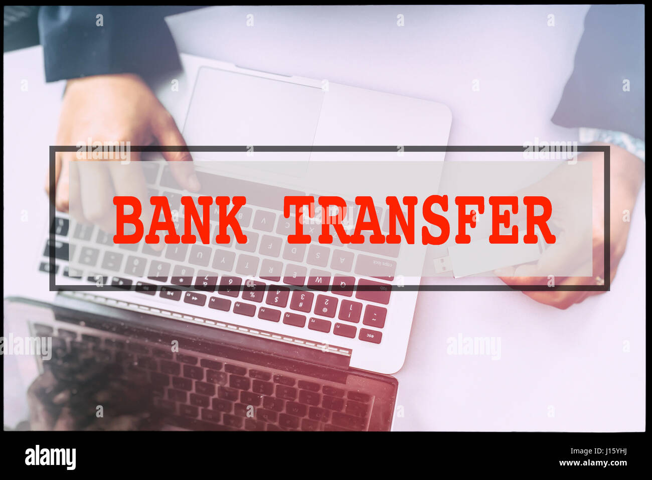 Hand and text BANK TRANSFER with vintage background. Technology concept ...