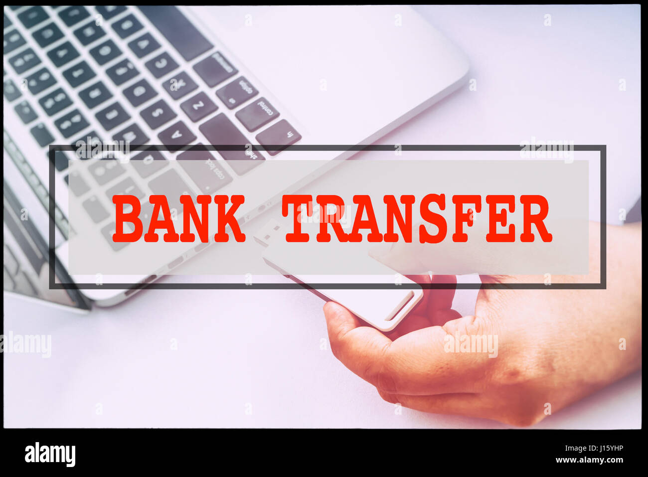 Hand and text BANK TRANSFER with vintage background. Technology concept ...