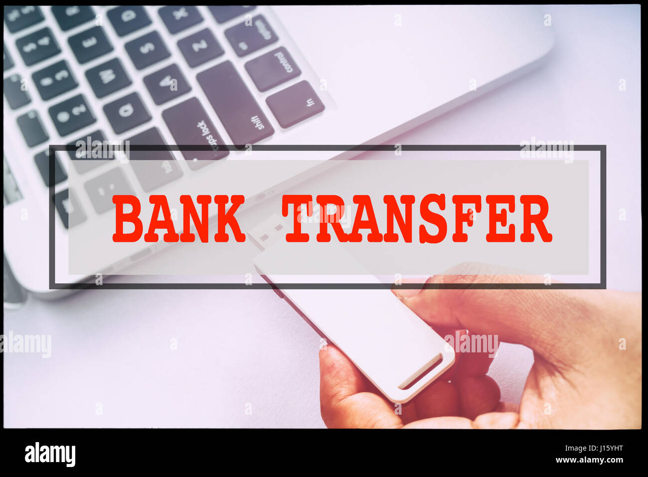 Hand and text BANK TRANSFER with vintage background. Technology concept ...