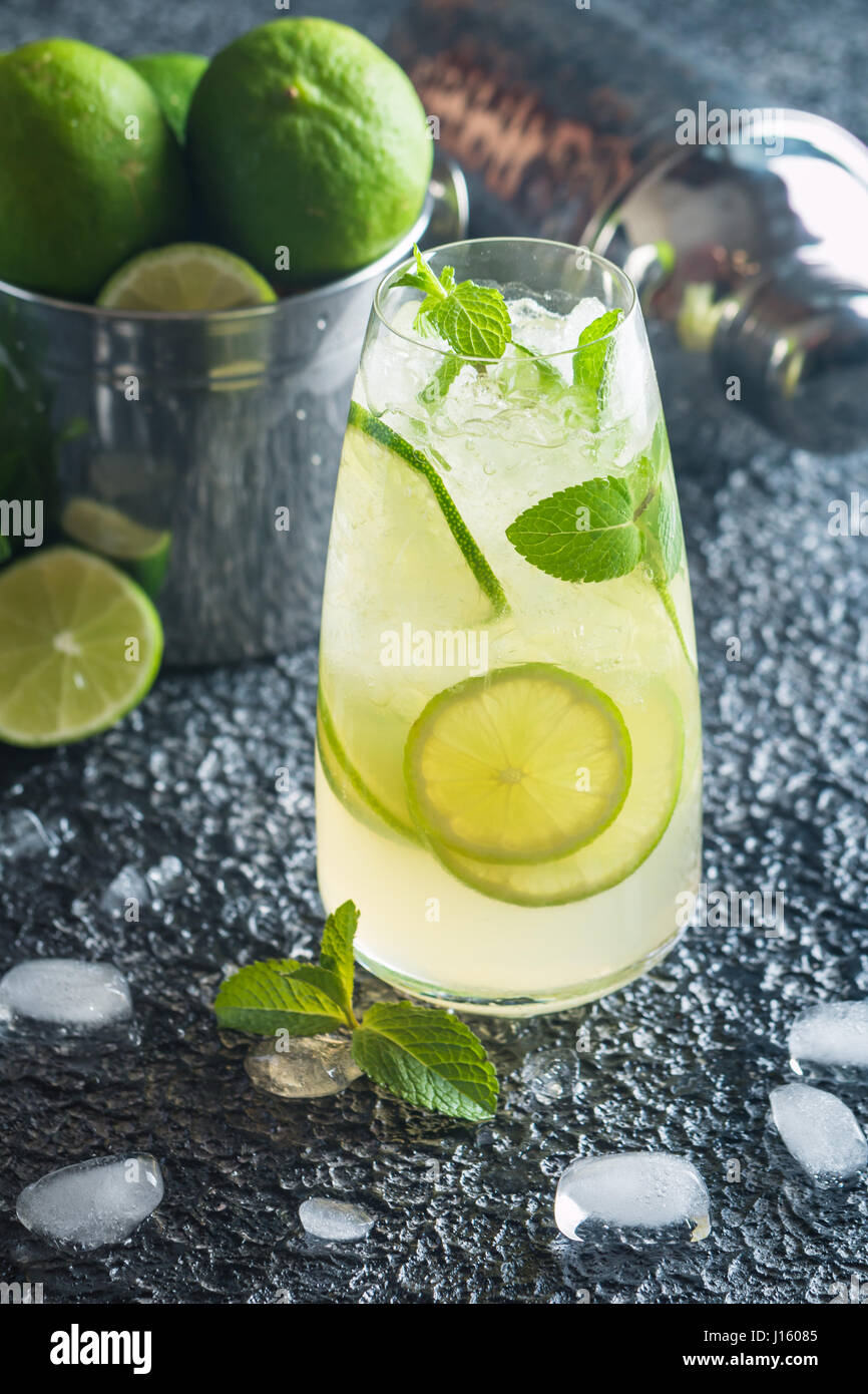 Mojito cocktail with lime and mint in highball glass on dark stone ...