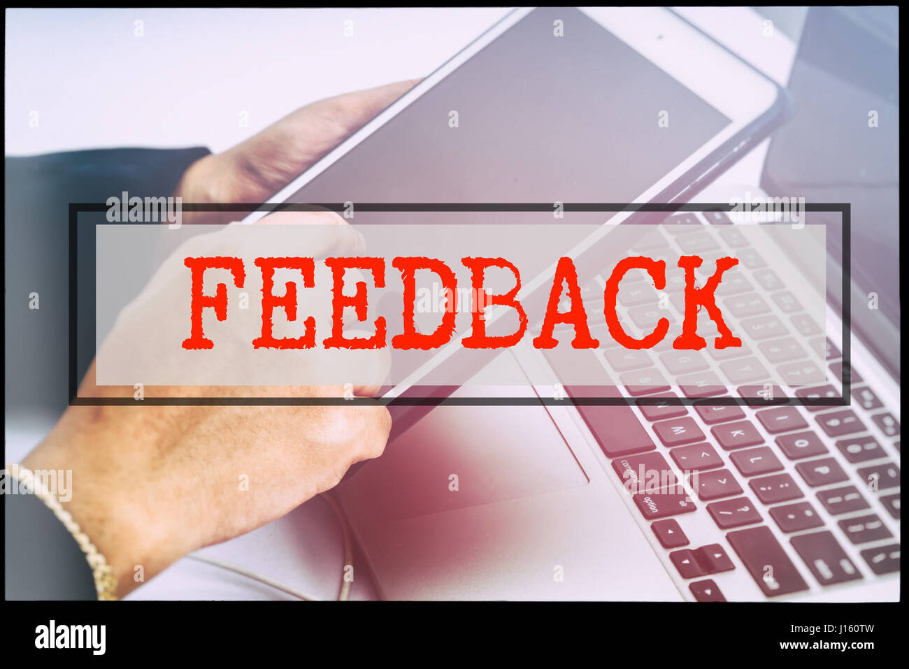 Hand and text FEEDBACK with vintage background. Technology concept ...