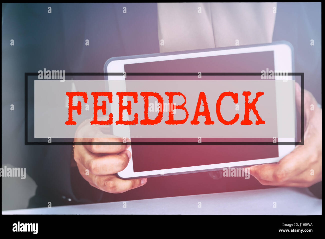 Hand and text FEEDBACK with vintage background. Technology concept ...