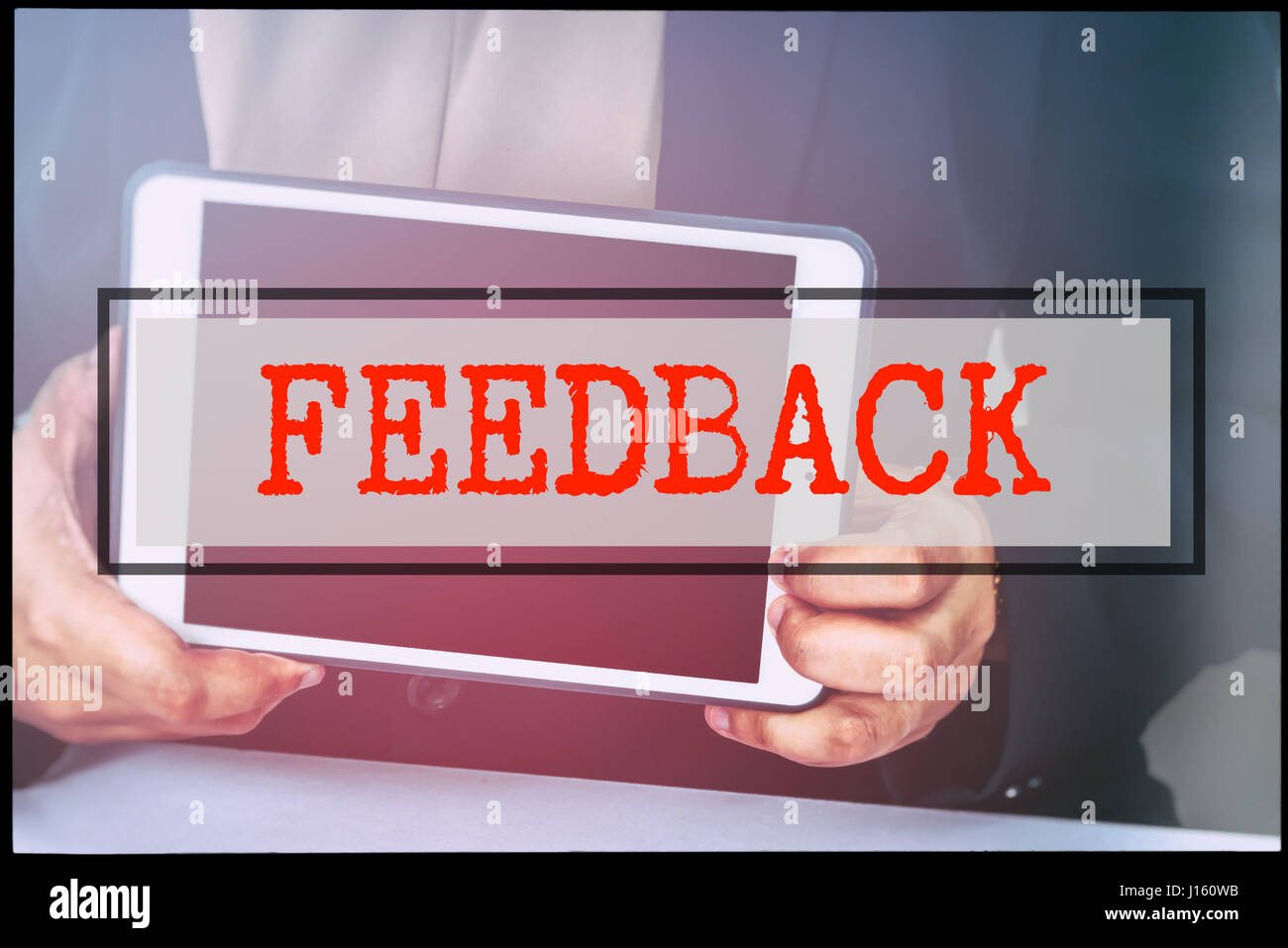 Hand and text FEEDBACK with vintage background. Technology concept ...