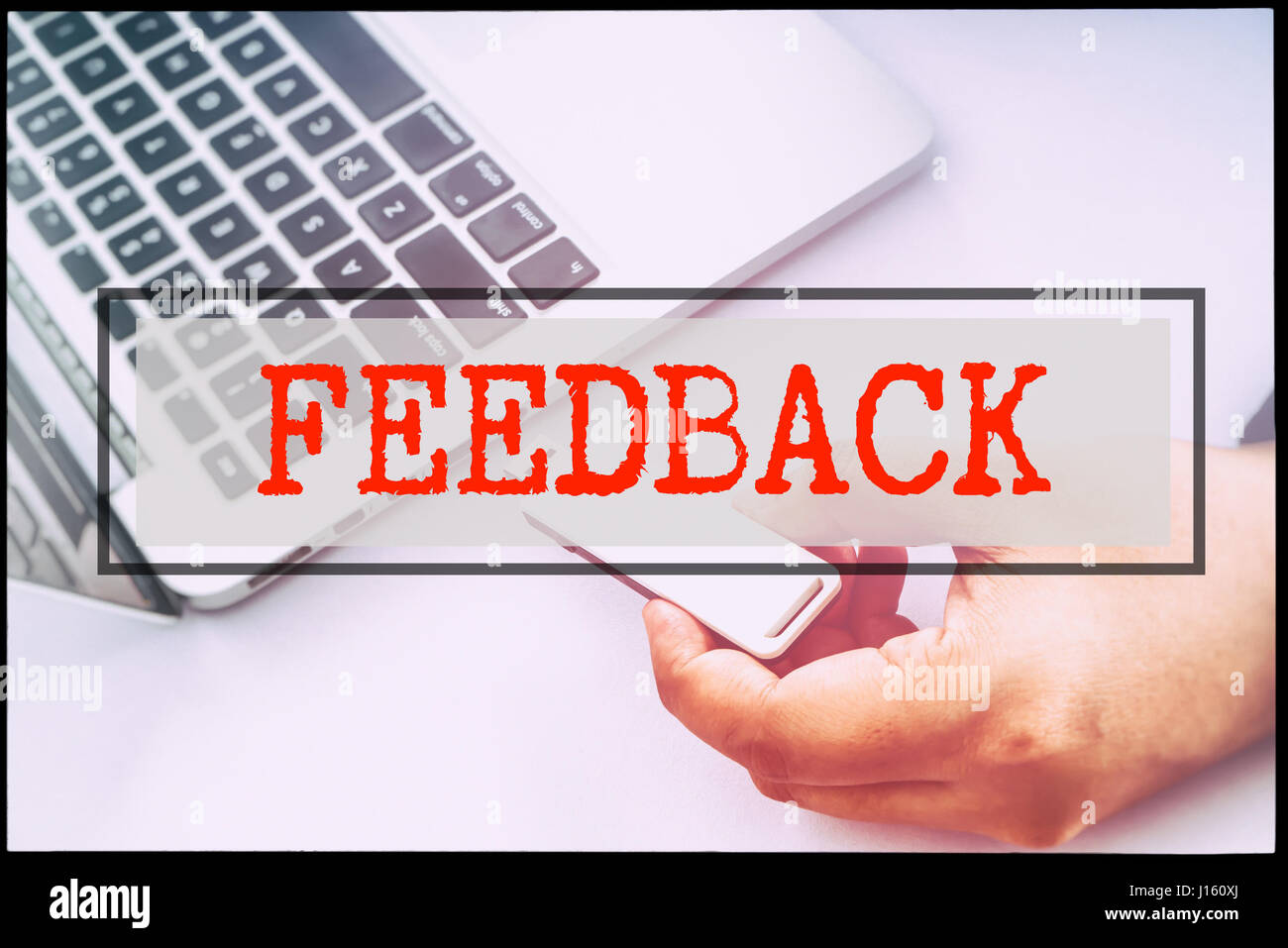 Hand and text FEEDBACK with vintage background. Technology concept ...