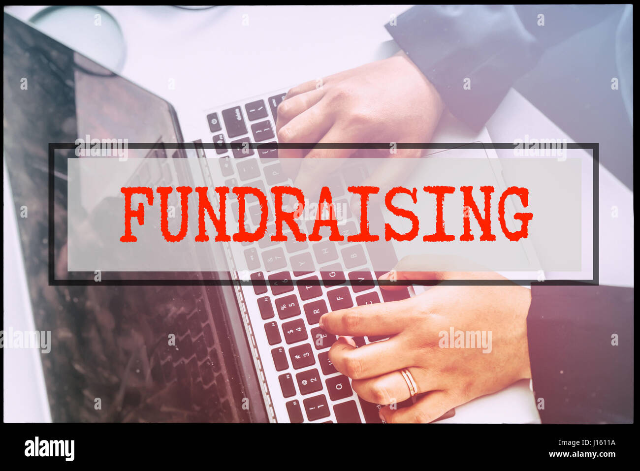 Hand and text FUNDRAISING with vintage backgound. Technology concept Stock Photo - Alamy