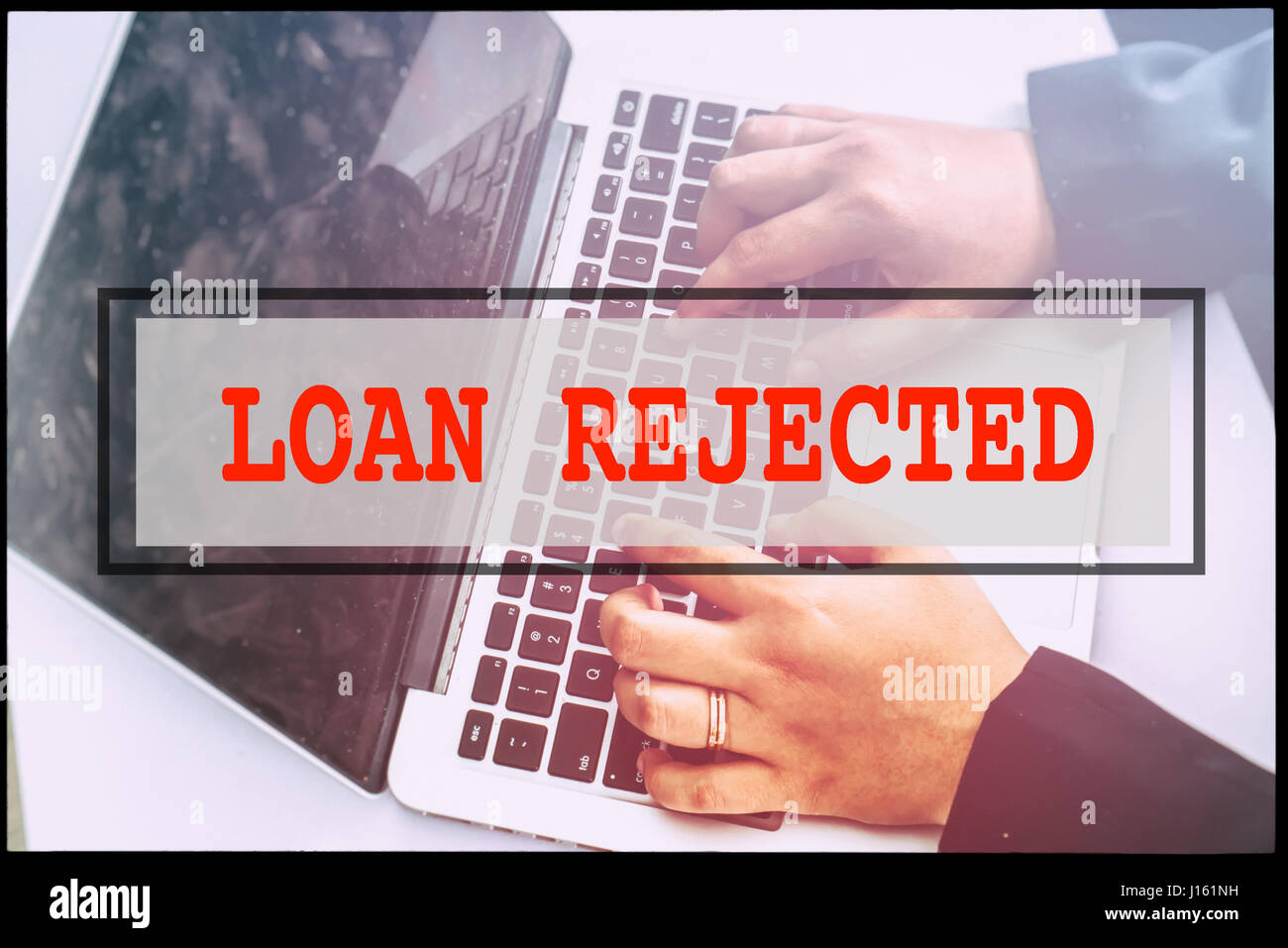 Hand and text LOAN REJECTED with vintage background. Technology concept ...