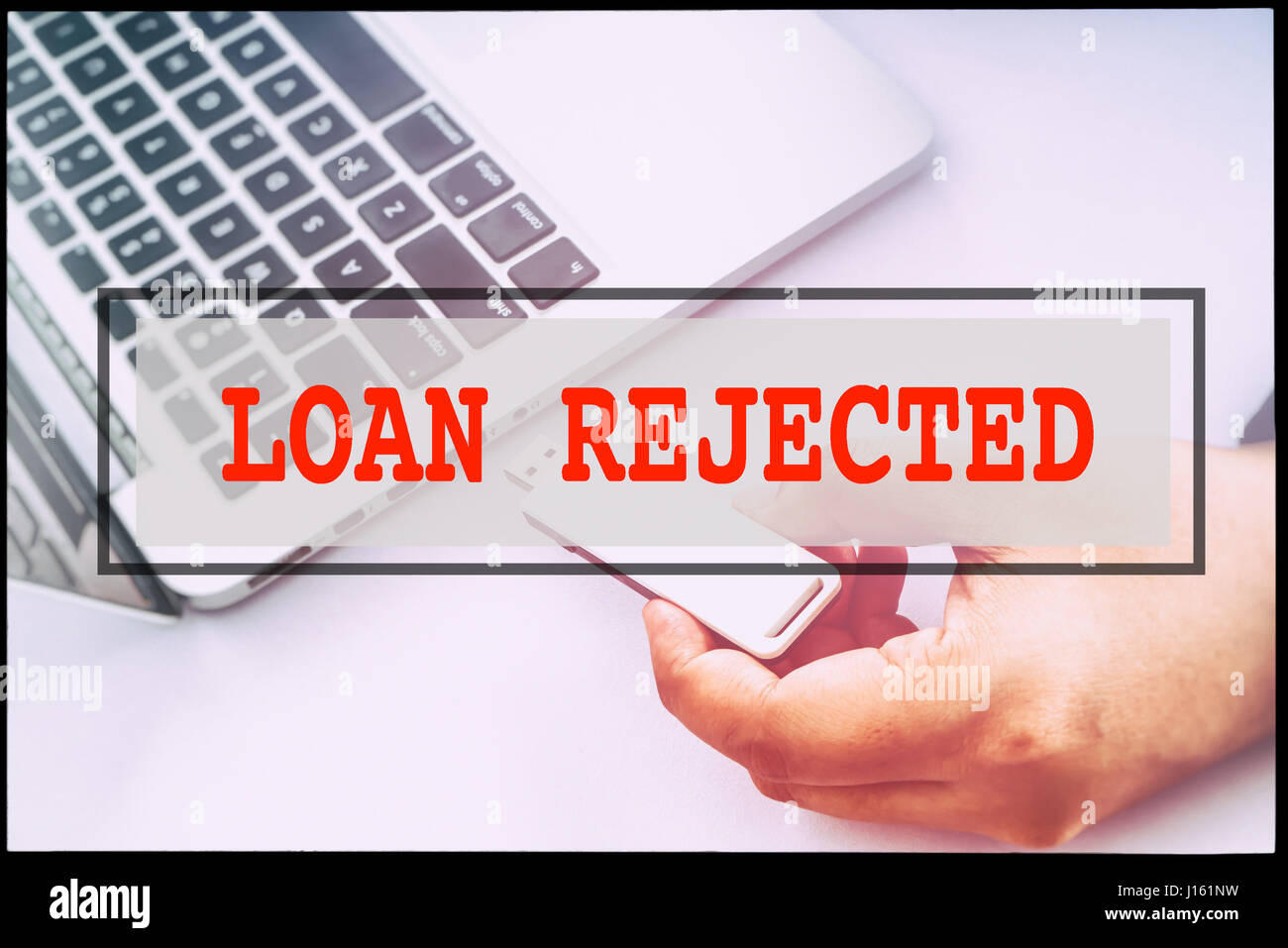 Hand and text LOAN REJECTED with vintage background. Technology concept ...
