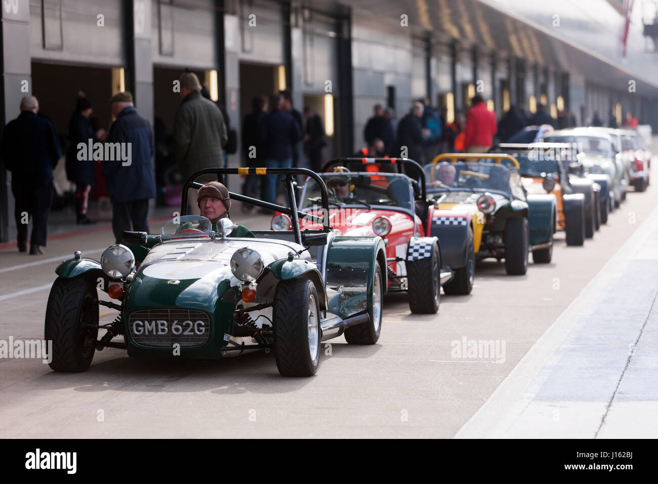 A group of classic Lotus 7 sports cars prepare to parade around the ...