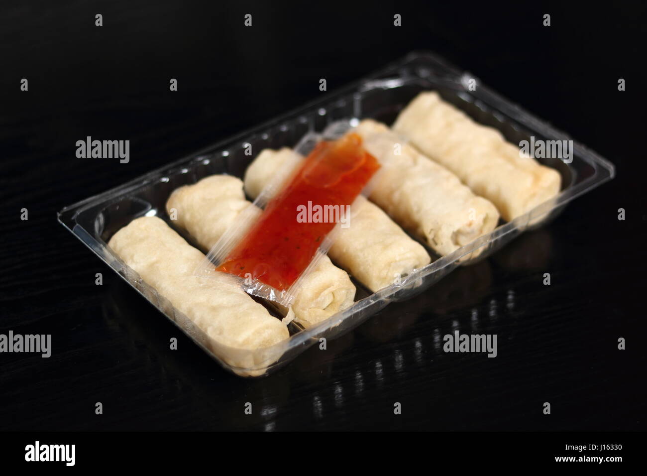 Spring roll in disposable plastic tray Stock Photo - Alamy