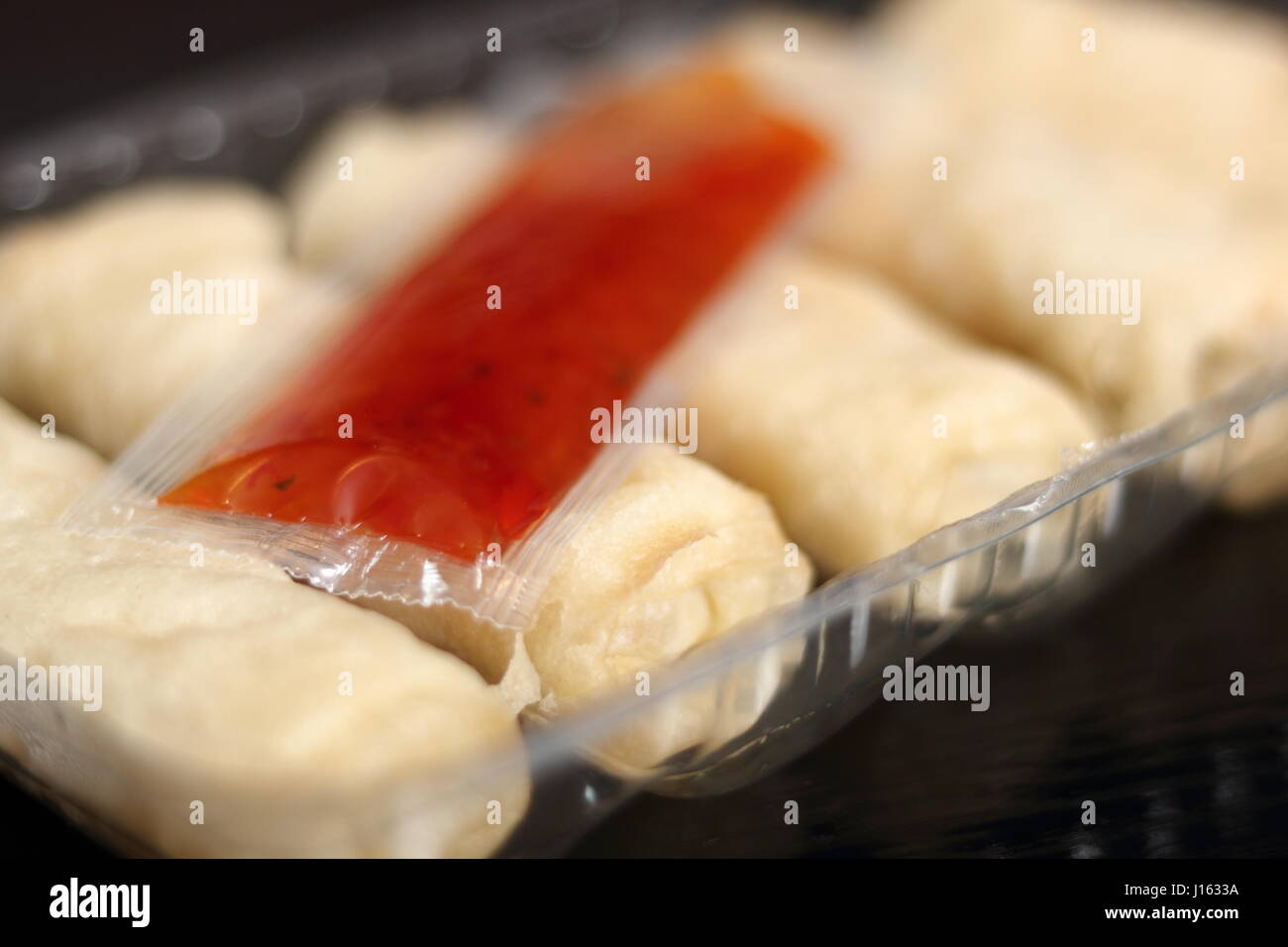 Spring roll in disposable plastic tray Stock Photo - Alamy
