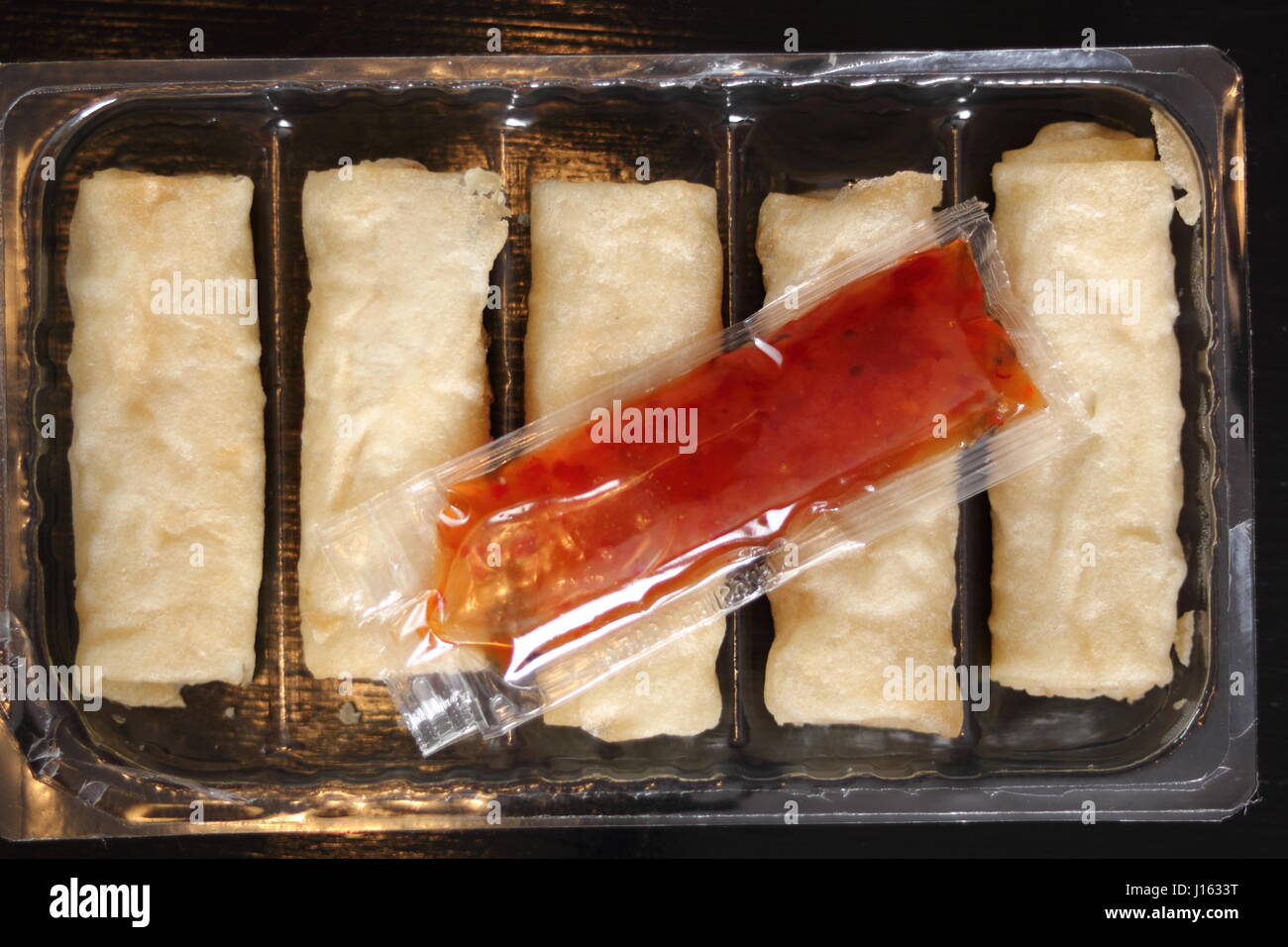 Spring roll in disposable plastic tray Stock Photo - Alamy