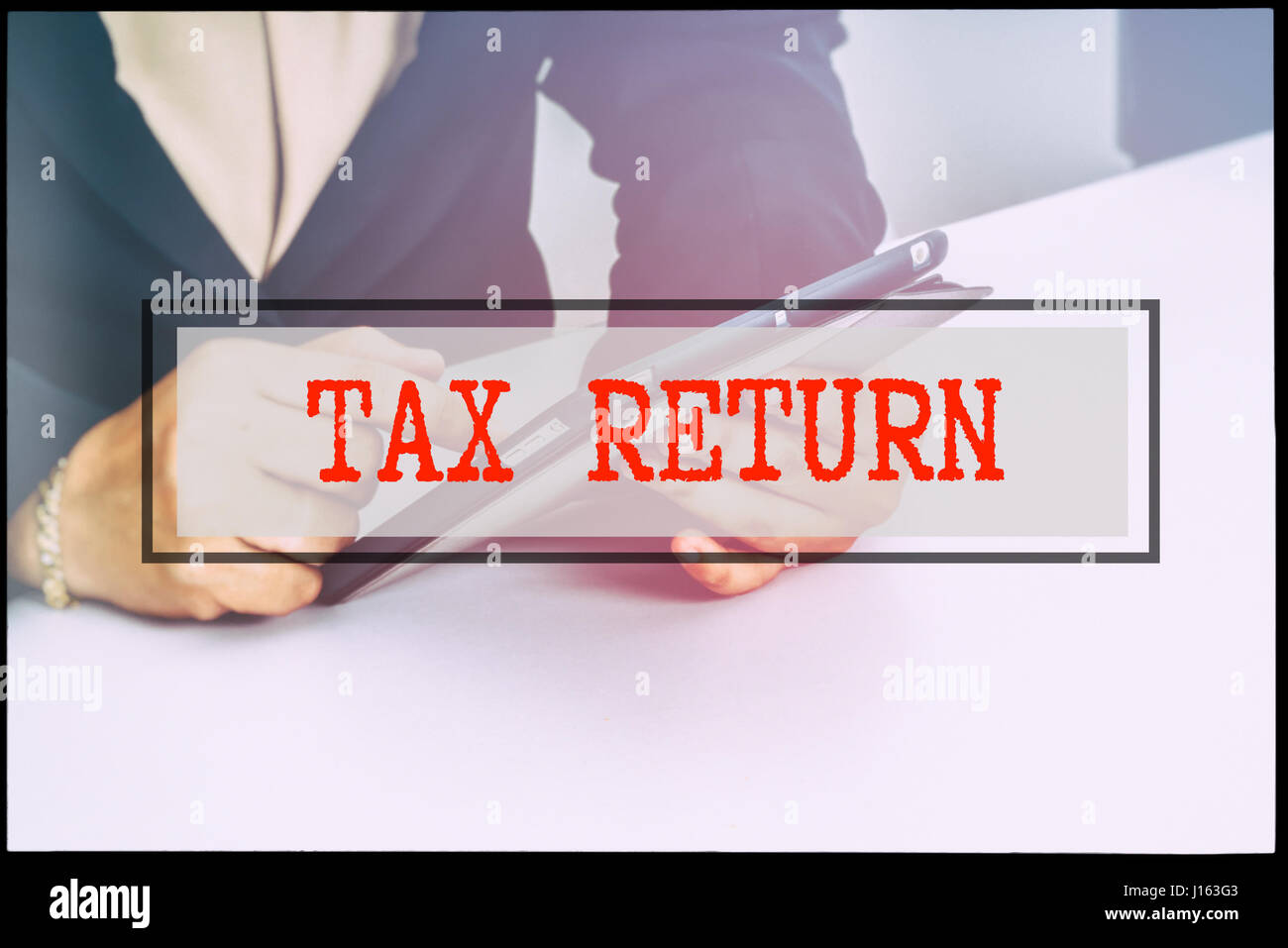 Hand and text TAX RETURN with vintage backgound. Technology concept ...