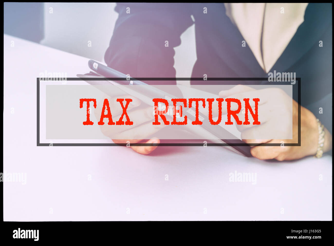 Hand and text TAX RETURN with vintage backgound. Technology concept ...