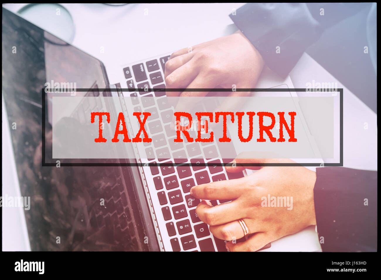 Hand and text TAX RETURN with vintage backgound. Technology concept ...