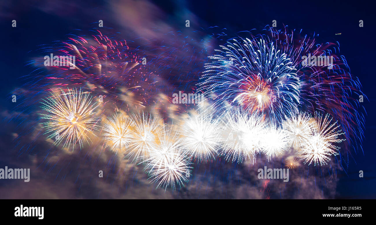 Multicolor fireworks with cityscape at night time Stock Photo - Alamy