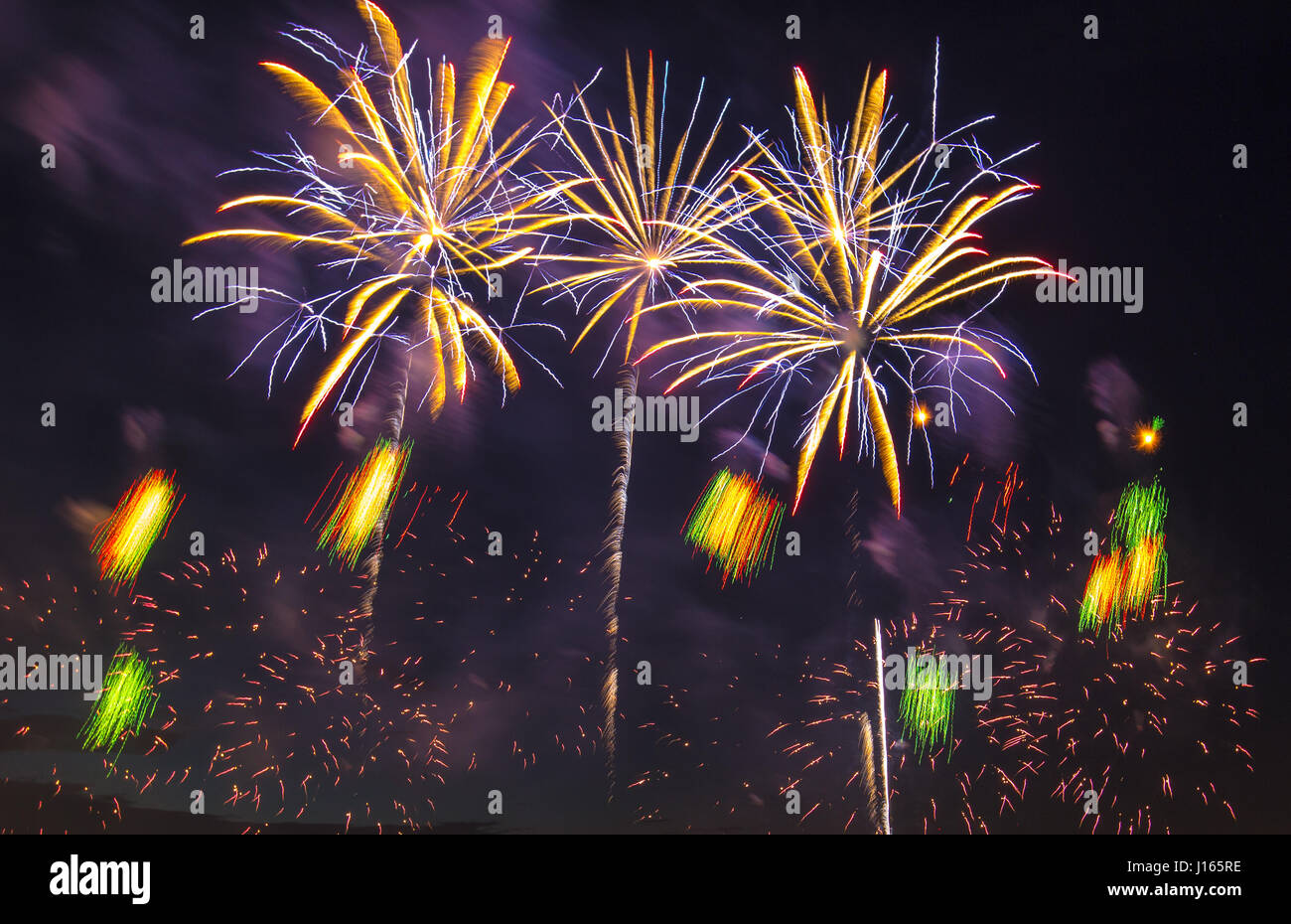 Multicolor fireworks with cityscape at night time Stock Photo - Alamy