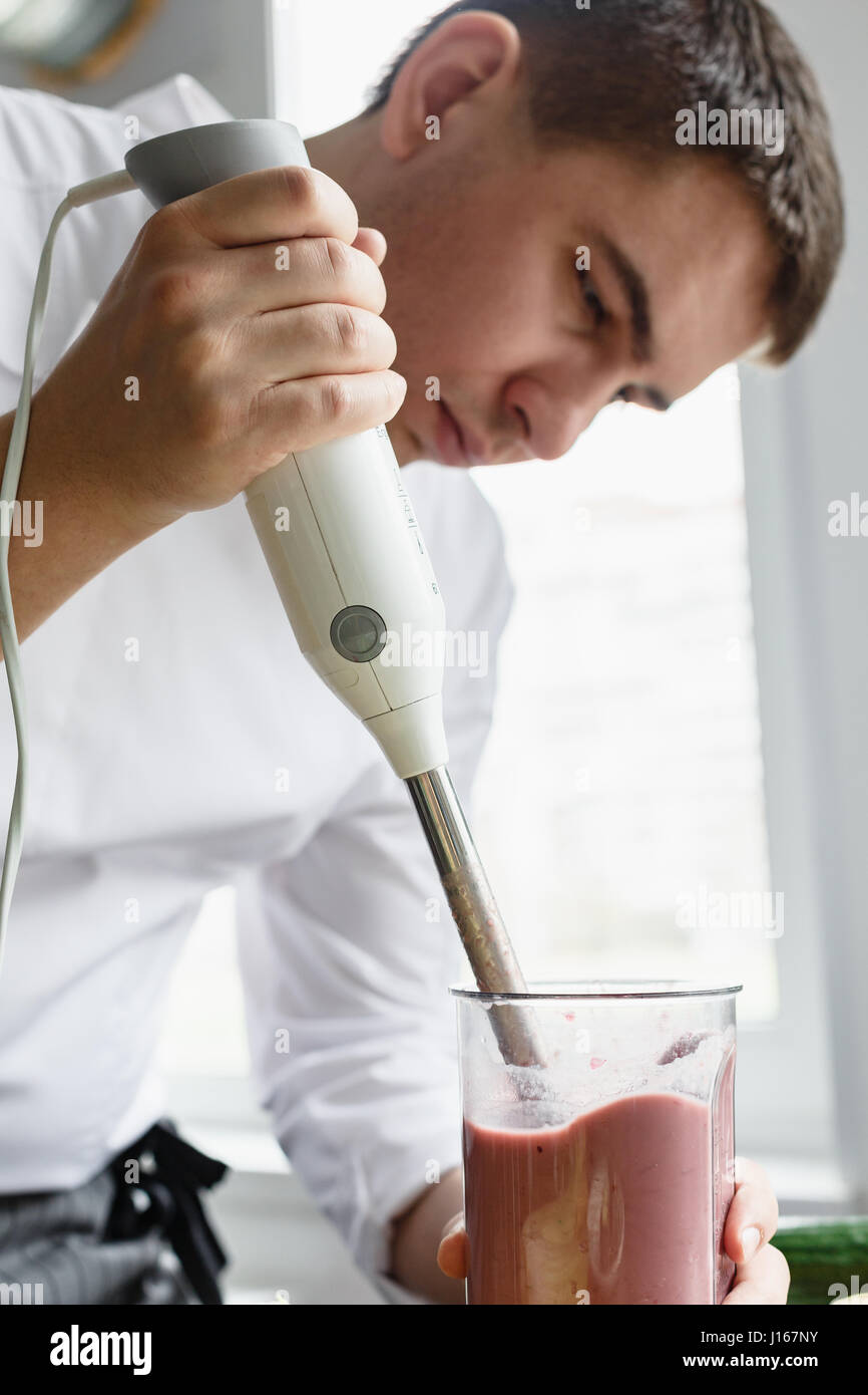 Young male preparing smoothie Stock Photo - Alamy