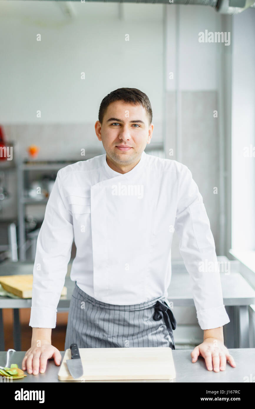 Young smiling male chef posing Stock Photo - Alamy