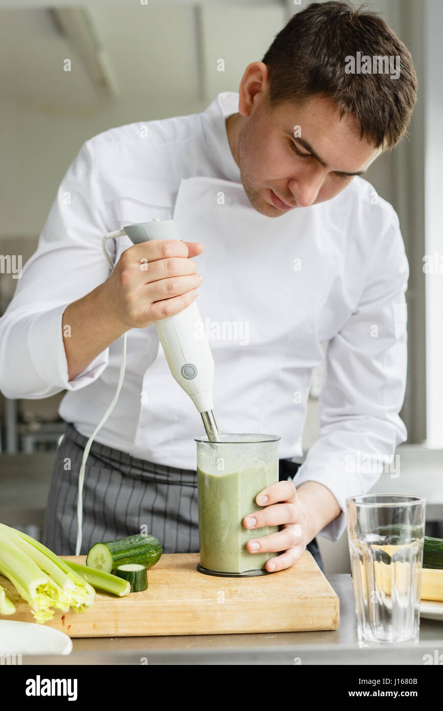 Young male chef making smoothie Stock Photo - Alamy