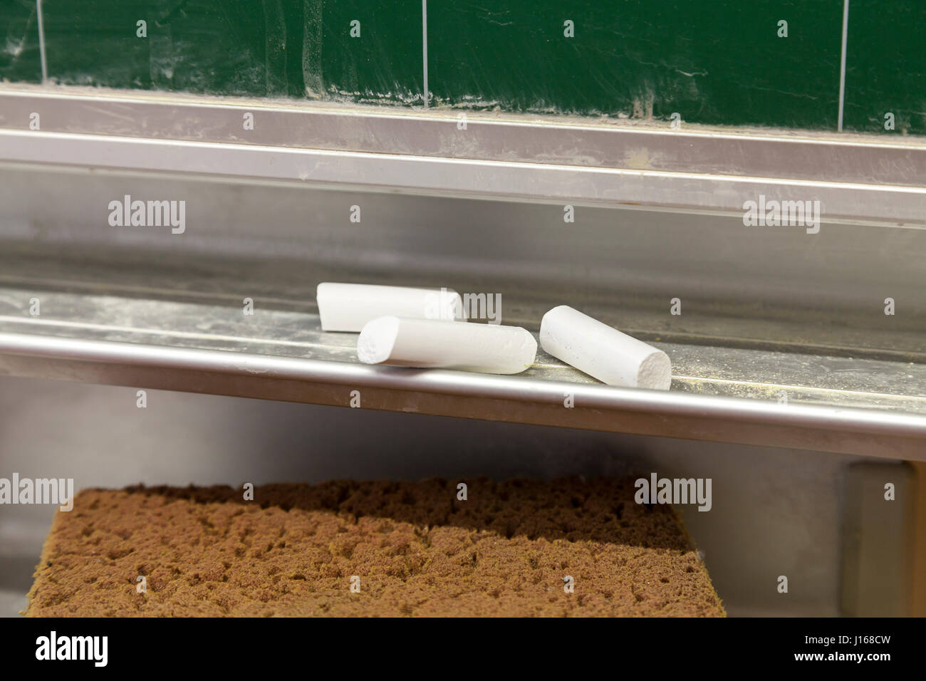 Chalk at blackboard in school Stock Photo - Alamy
