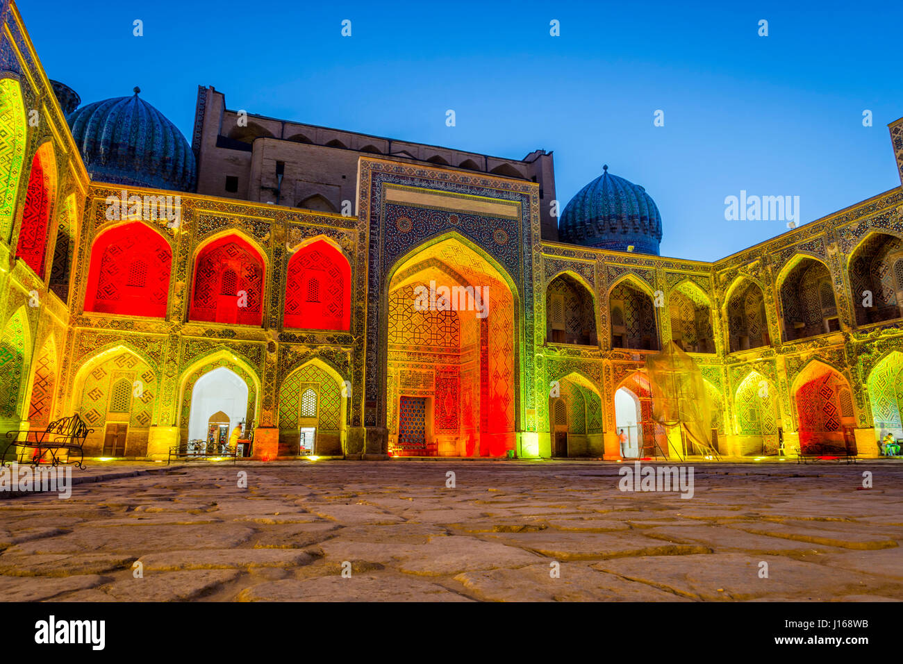 Illuminated colorful atrium of Sher-Dor Madrasah at night, Samarkand ...