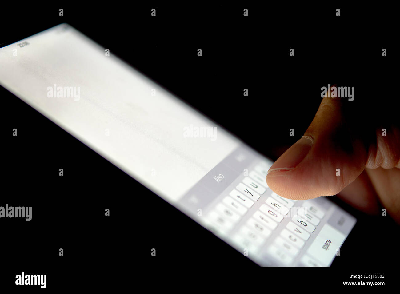 Closeup for pointing finger on screen smart phone with light from ...
