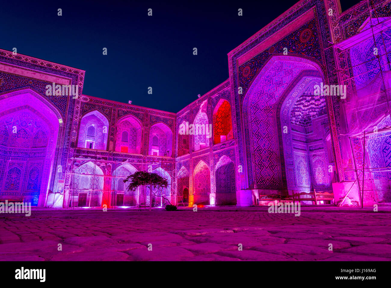 Illuminated colorful atrium of Sher-Dor Madrasah at night, Samarkand ...