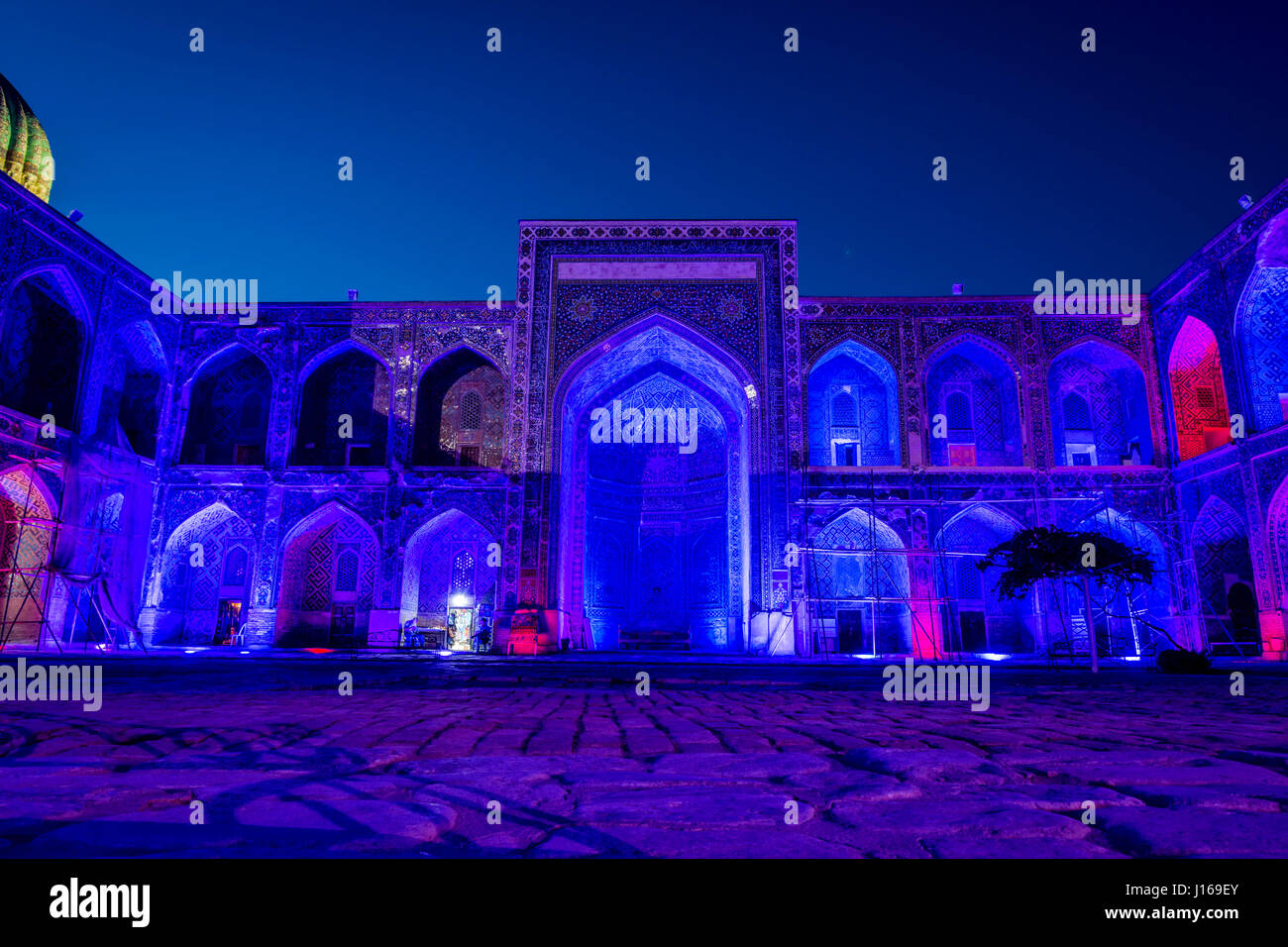 Illuminated colorful atrium of Sher-Dor Madrasah at night, Samarkand ...