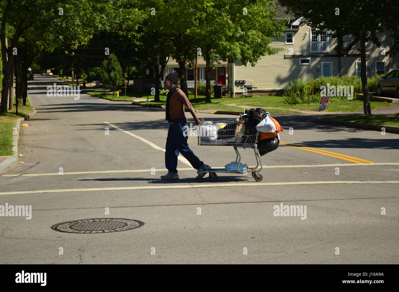 Homeless man with possessions in shopping cart Stock Photo - Alamy