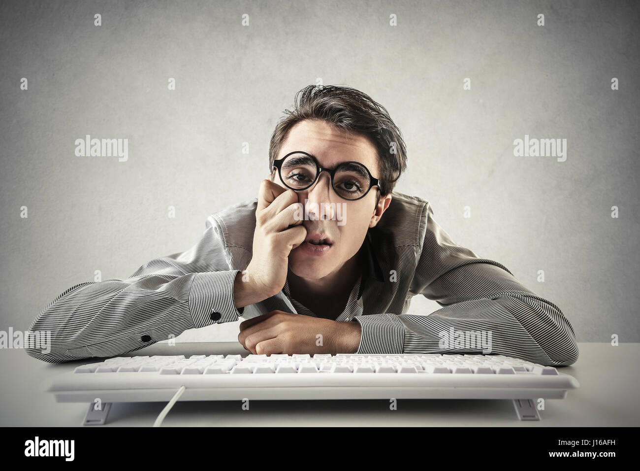 Businessman being tired in front of computer Stock Photo - Alamy
