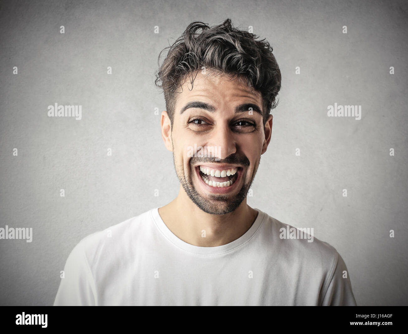 Handsome man laughing Stock Photo - Alamy