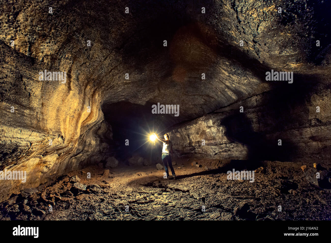 VARIOUS LOCATIONS, WORLDWIDE: A woman explores inside a cavern ...