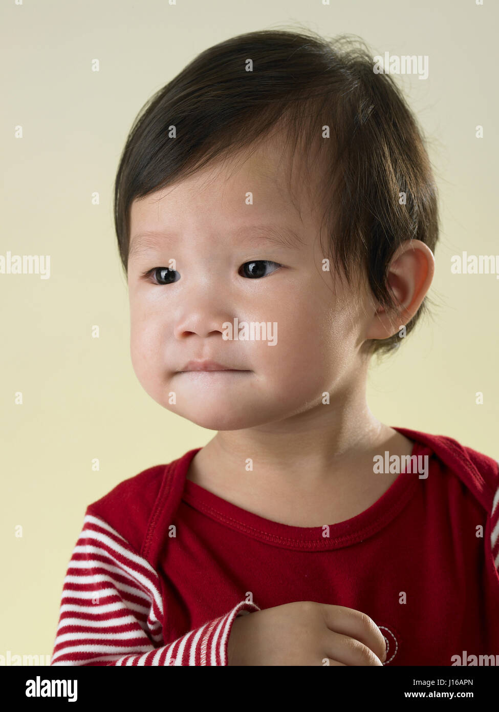 Child biting lip hi-res stock photography and images - Alamy