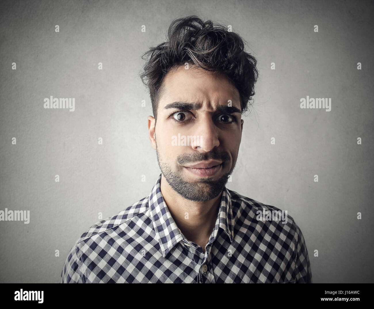 Handsome man looking confused Stock Photo - Alamy