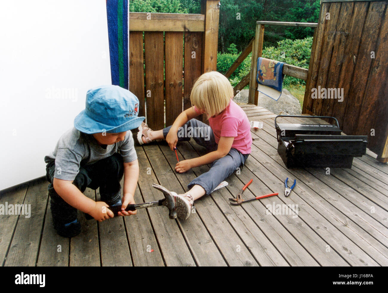 CHILD plays with tools on the patio 2004 Stock Photo - Alamy
