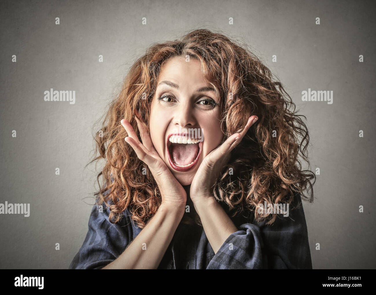 Brunette woman looking happy Stock Photo - Alamy